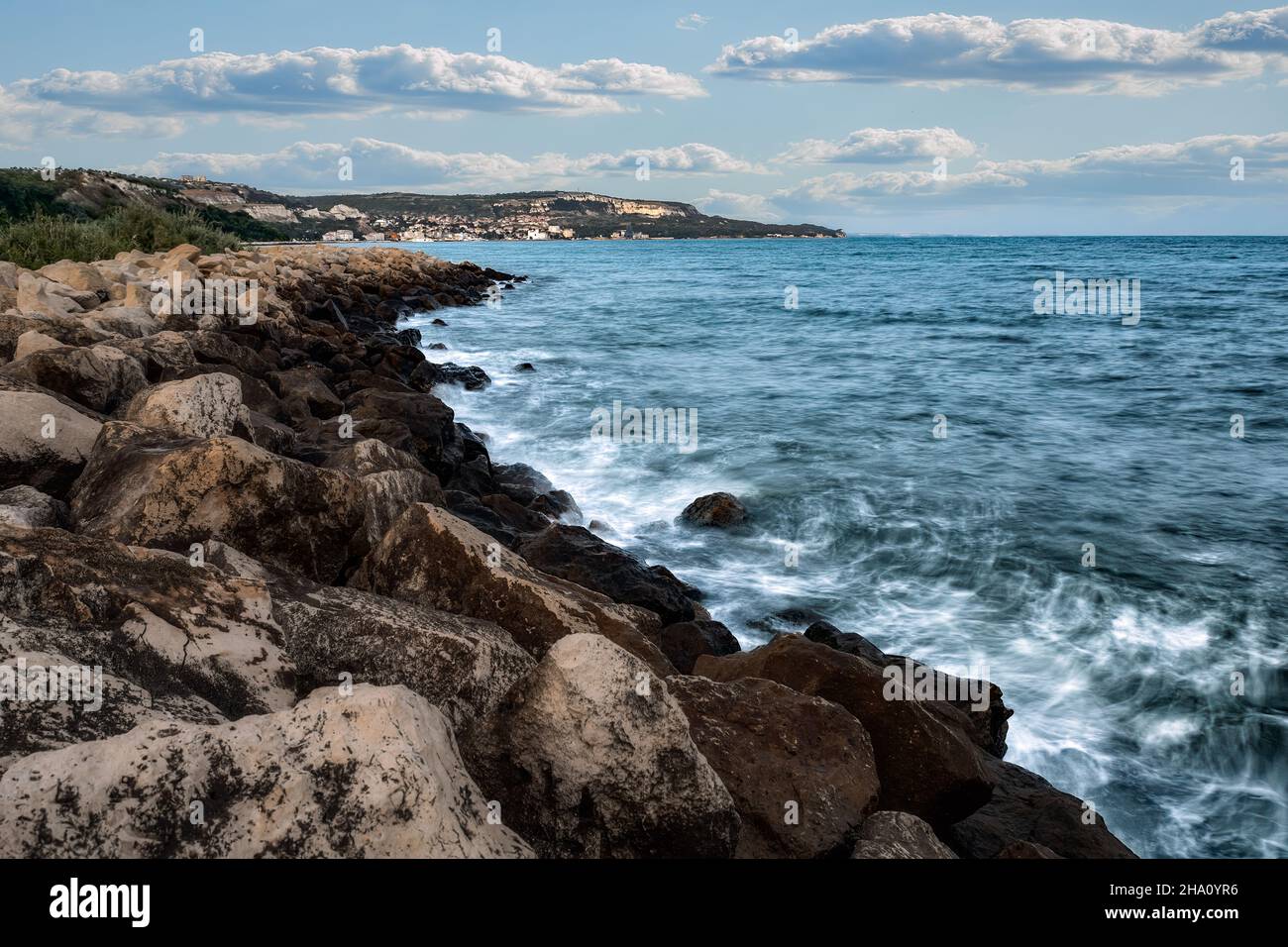 Mesmerizing view of big pieces of rocks on the coast of the sea against ...