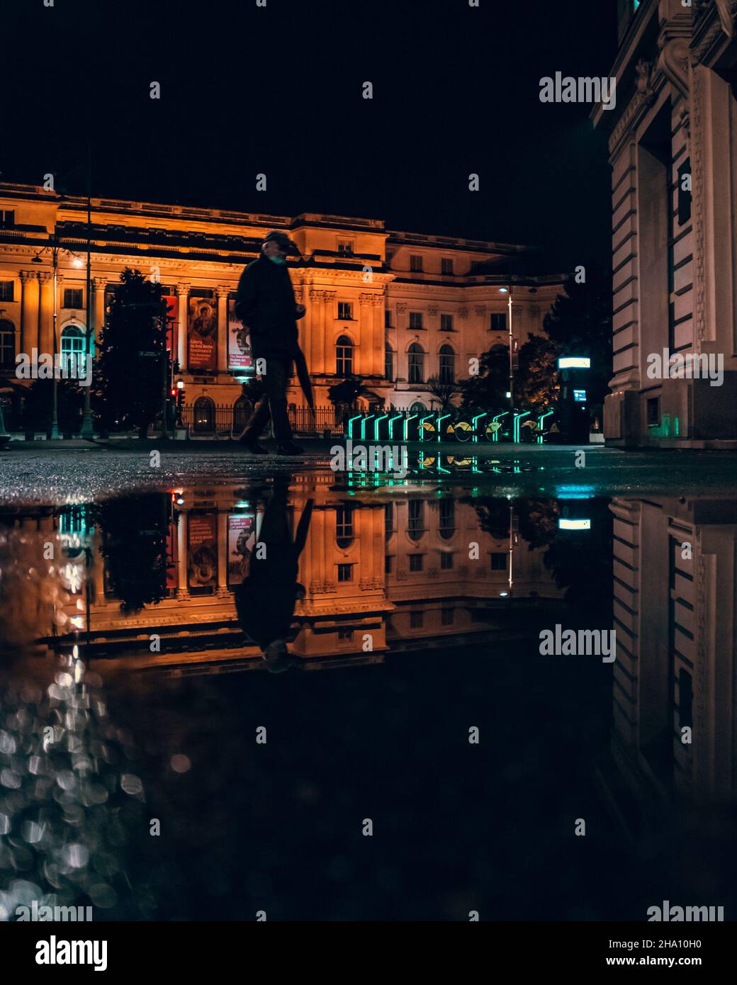 Beautiful night view of a human walking in the street on a cold day ...