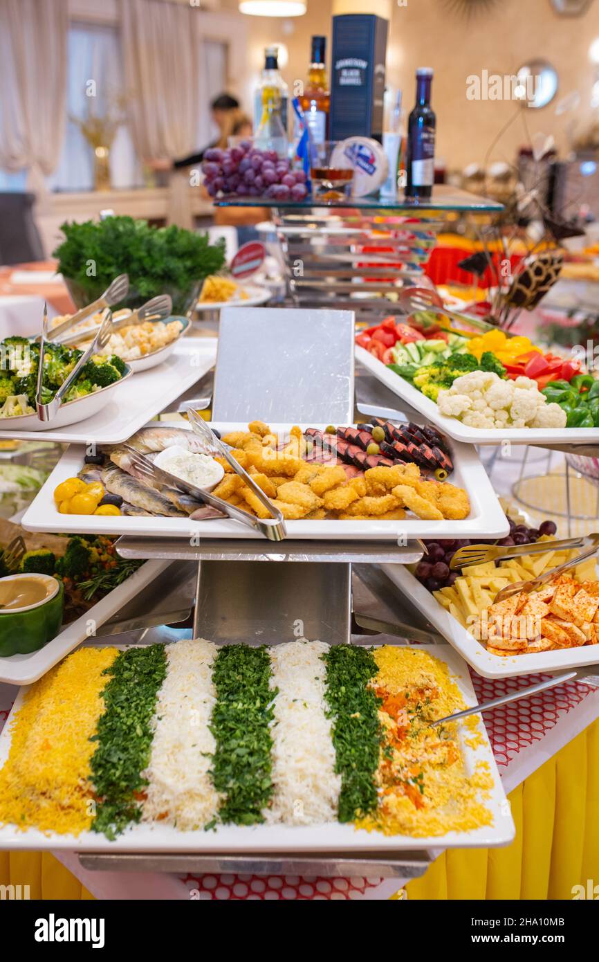 fish slicing and various dishes on the buffet in the restaurant Stock ...