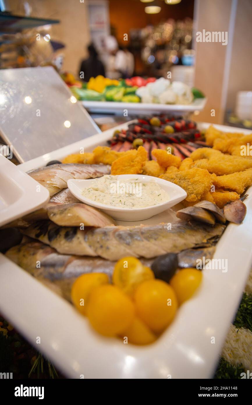 fish slicing and various dishes on the buffet in the restaurant Stock ...