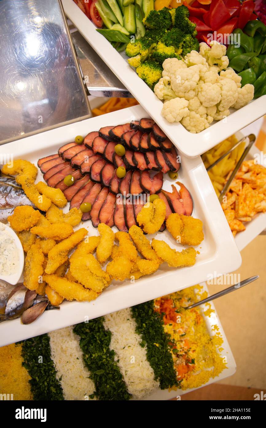 fish slicing and various dishes on the buffet in the restaurant Stock ...