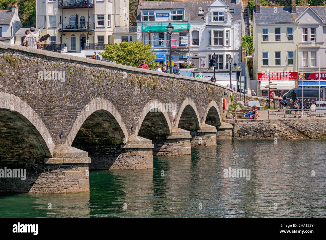 The Grade II listed bridge over the East Looe River with hillside ...