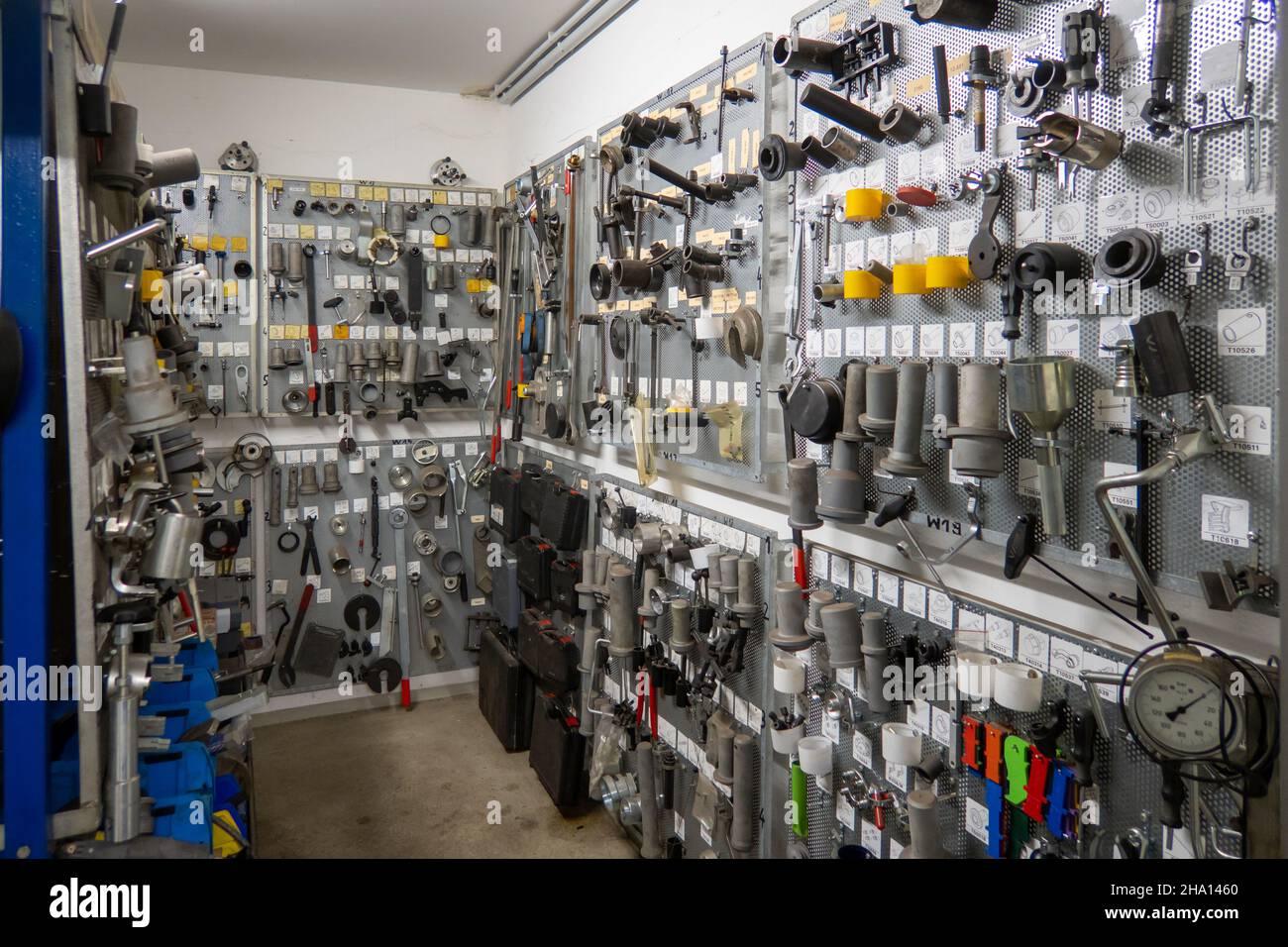in a car workshop a room with many tools and spare parts on the wall ...