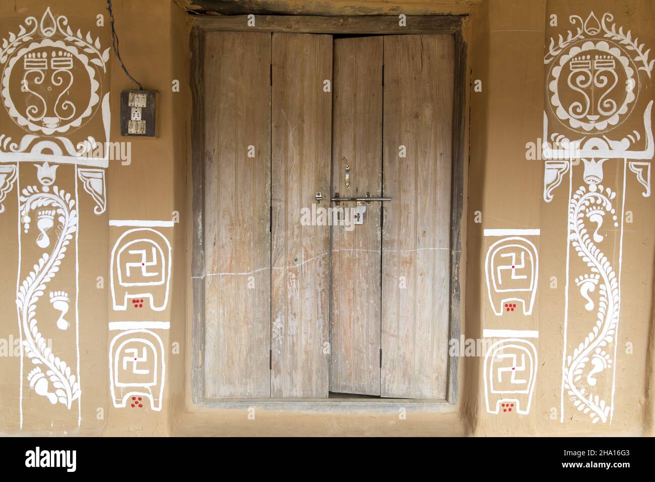 Drawing of patterns and symbols on the wall near the old wooden window ...