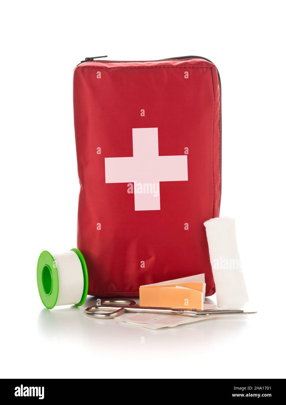 Red first aid medical kit bag with scissors, tape and gloves standing ...