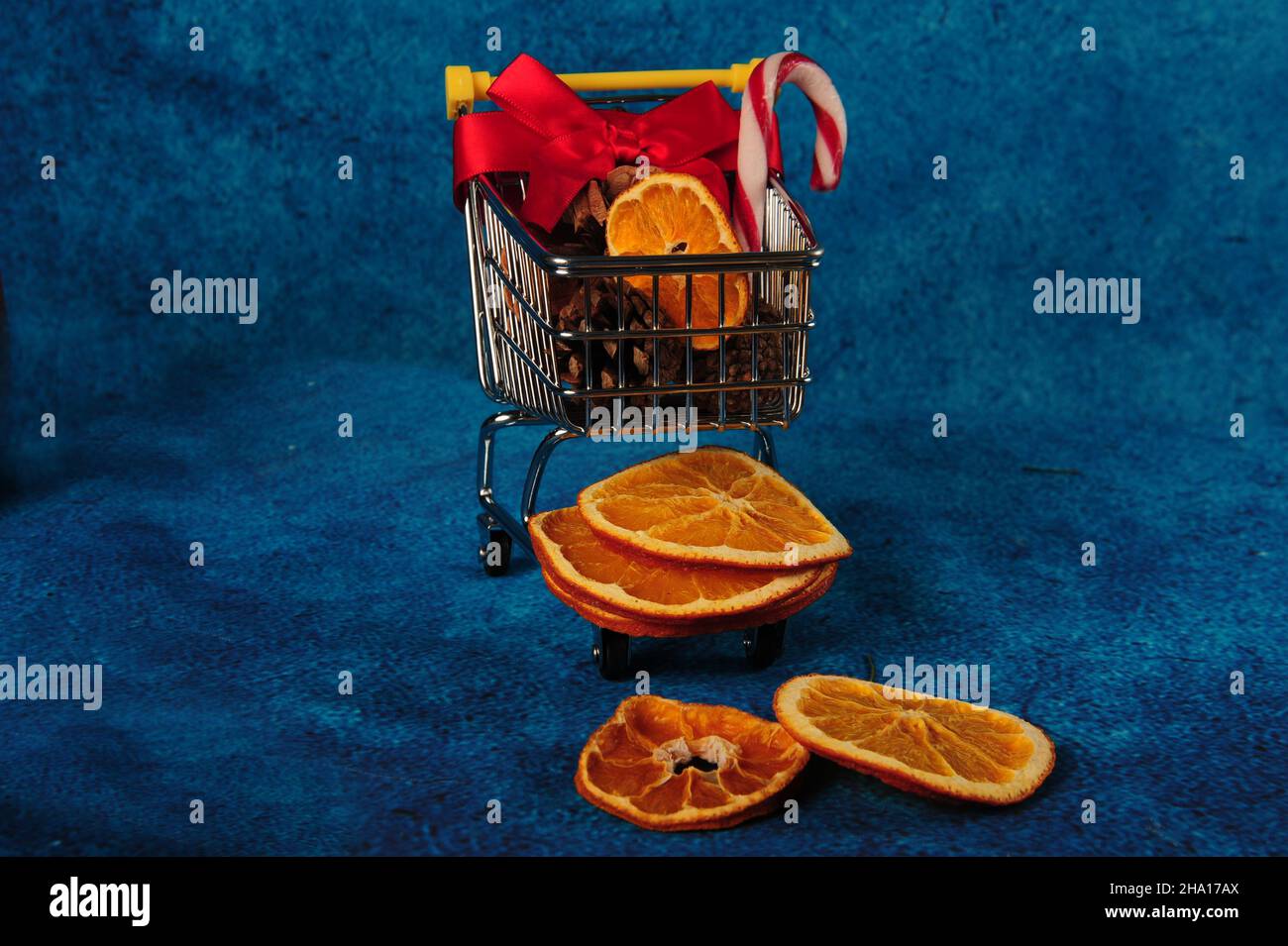 Miniature shopping cart with red bow, orange slices, candy cane and ...