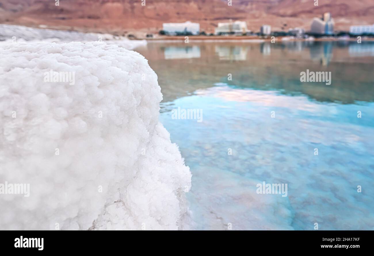 Sand completely covered with crystalline salt, in background blurred ...