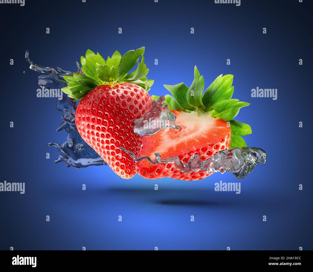 strawberries in water splash on a blue background Stock Photo - Alamy
