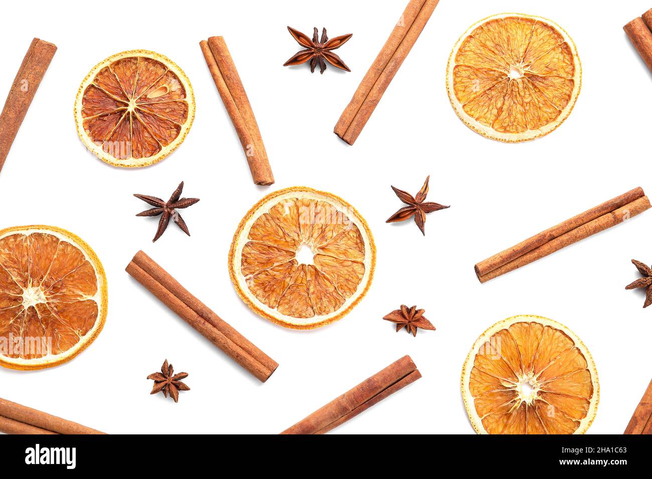 Composition with cinnamon sticks and slices of dried orange on white ...