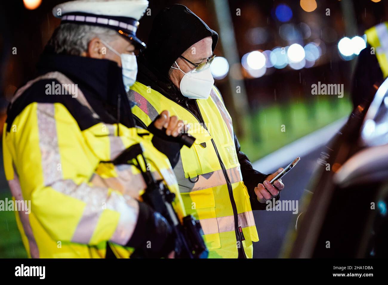 Mannheim, Germany. 09th Dec, 2021. Police officers check the curfew for ...