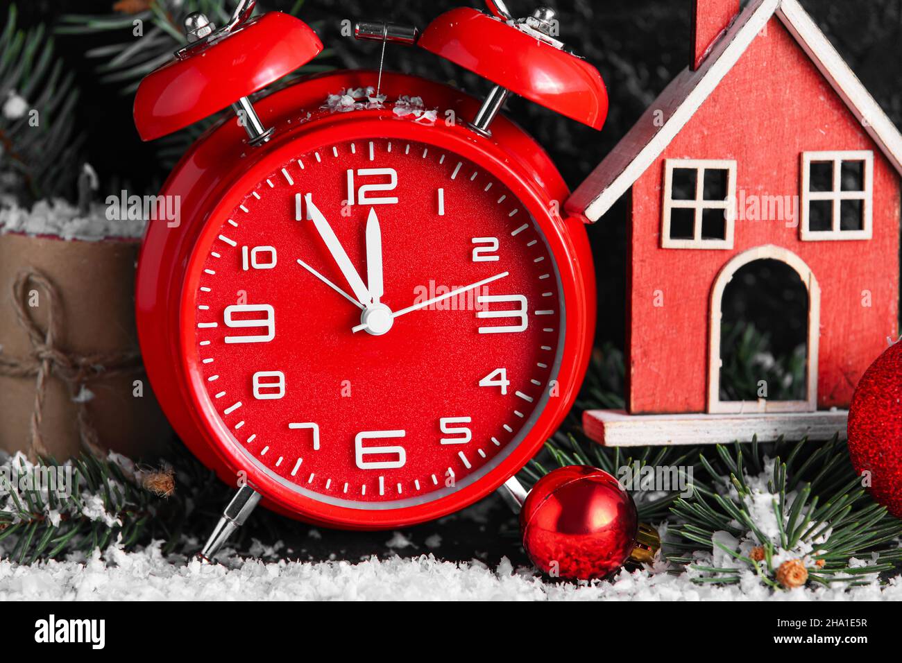 Red alarm clock and Christmas decorations, closeup Stock Photo - Alamy