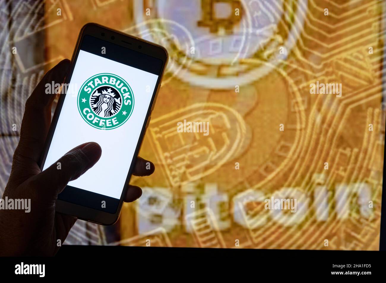 In this photo illustration the Starbucks logo is seen on the screen of ...