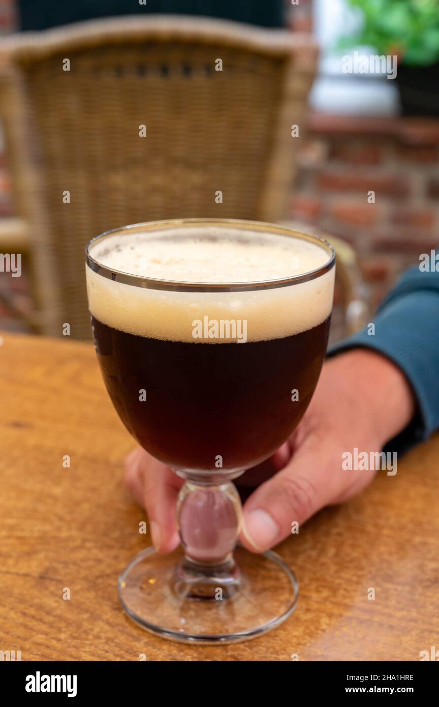Glass of dark tasty Belgian dubbel brown beer from abbey brewery served ...