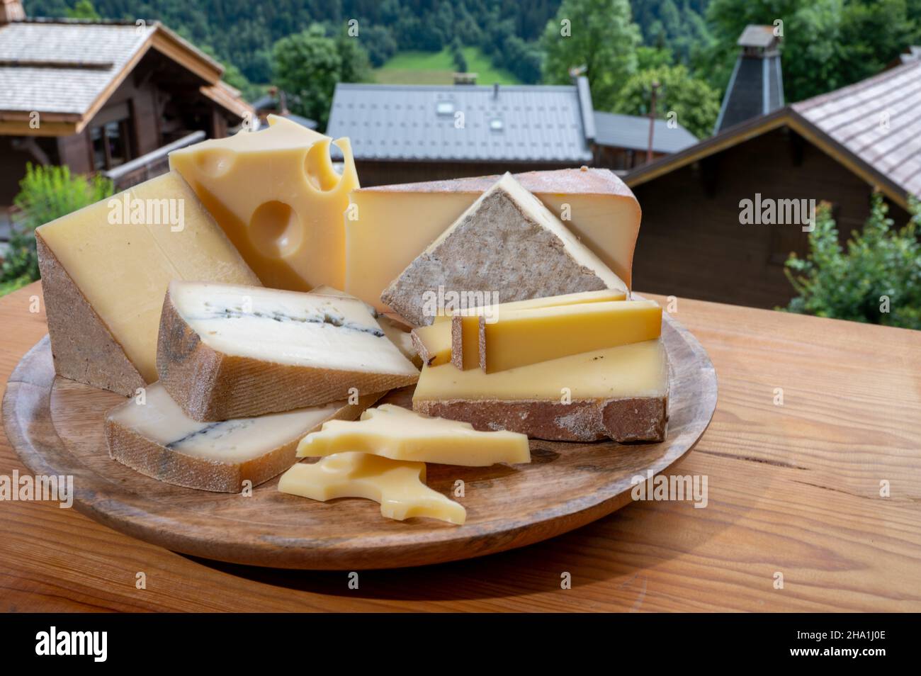 Cheese collection, wooden board with French cheeses comte, beaufort ...