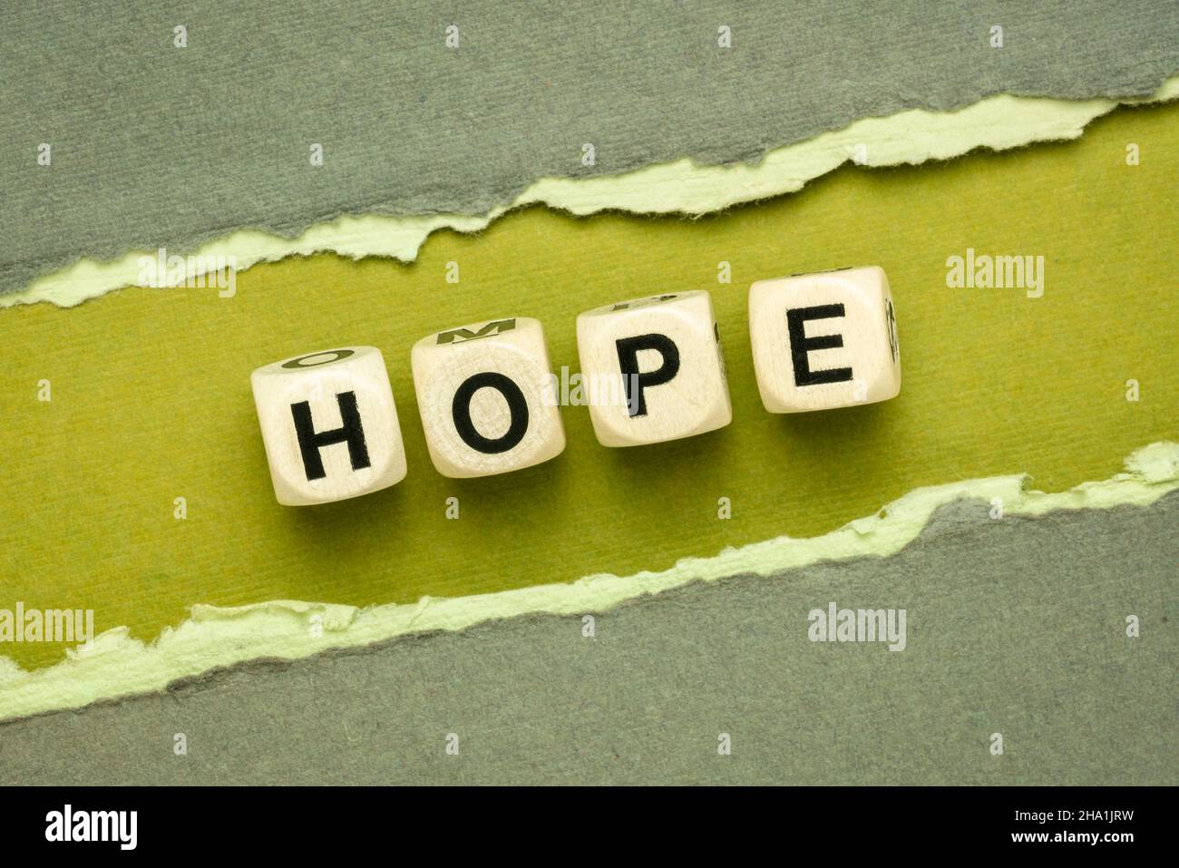 hope word - word abstract in wooden letter cubes against abstract paper ...