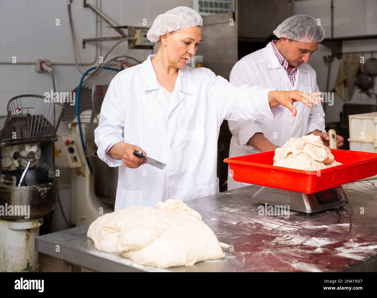 Bakers weigh the dough on the scales Stock Photo - Alamy
