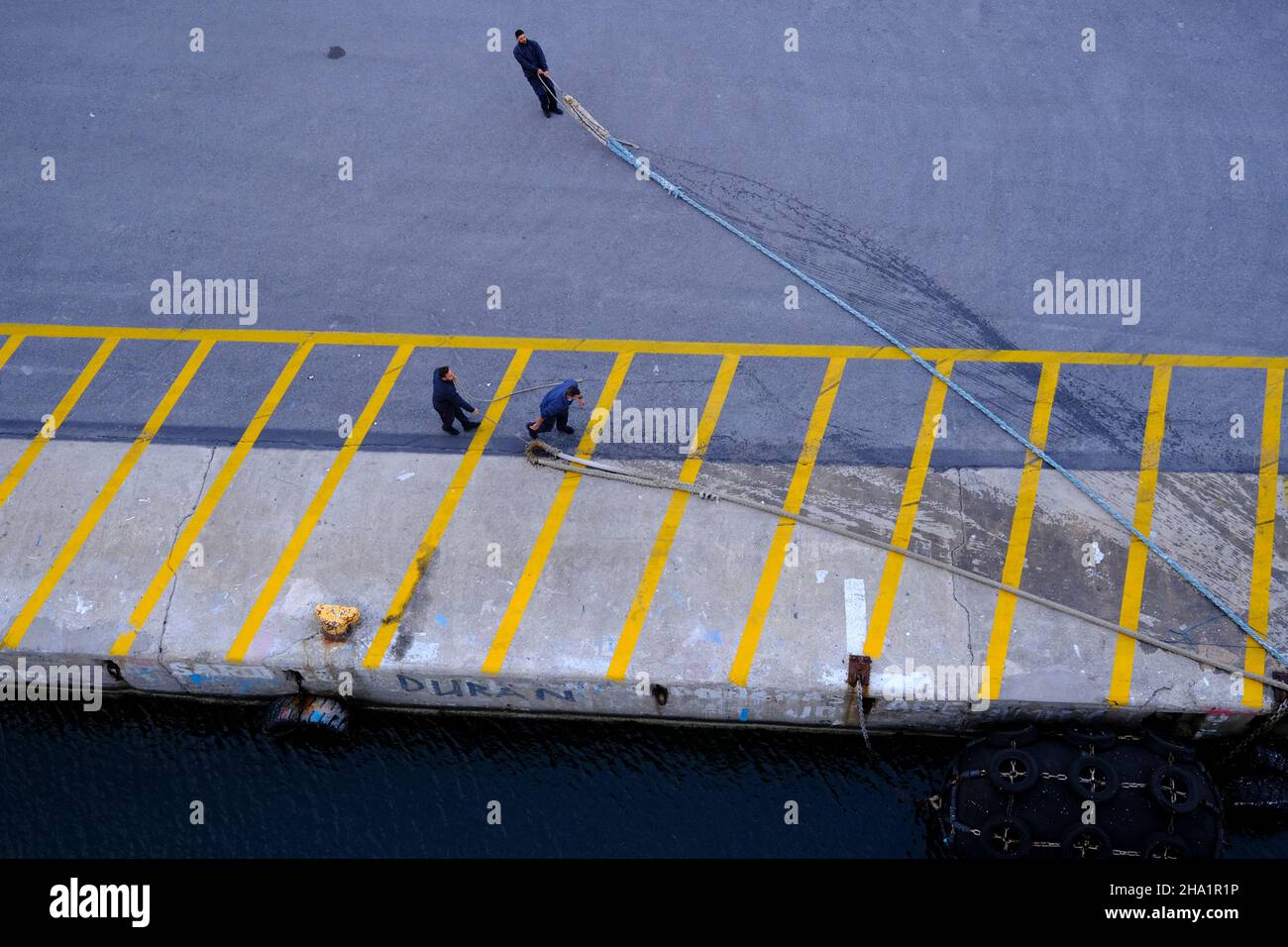 Crew pulling in the ropes preparing to dock a cruise ship Stock Photo ...