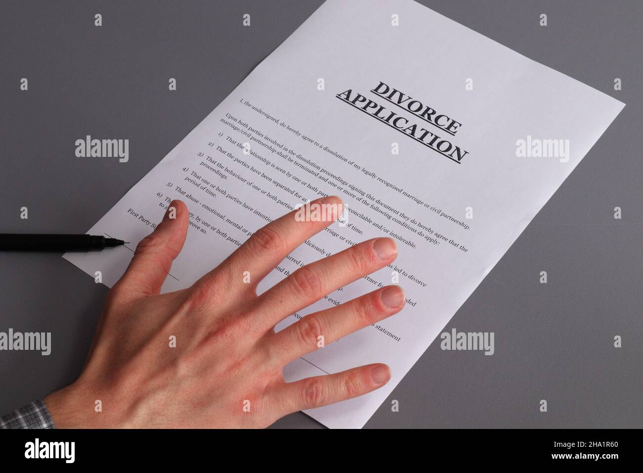 A hand hovering over divorce papers Stock Photo - Alamy