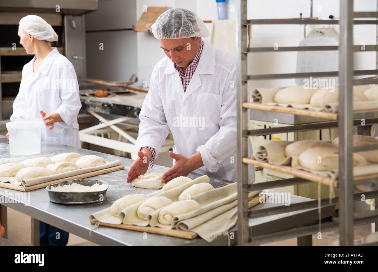 Portrait of experienced professional baker during daily work in kitchen ...