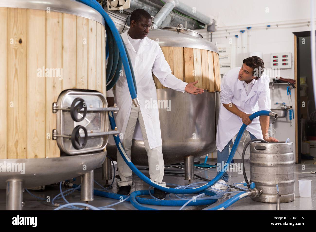 Brewers working on his workplace in the brew-house Stock Photo - Alamy