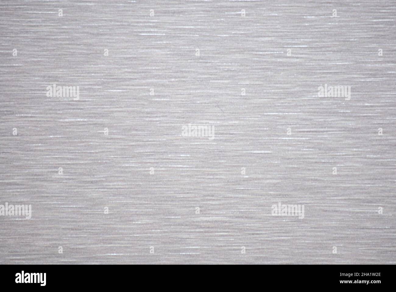 A flat surface of silver-colored metal with parallel horizontal stripes ...