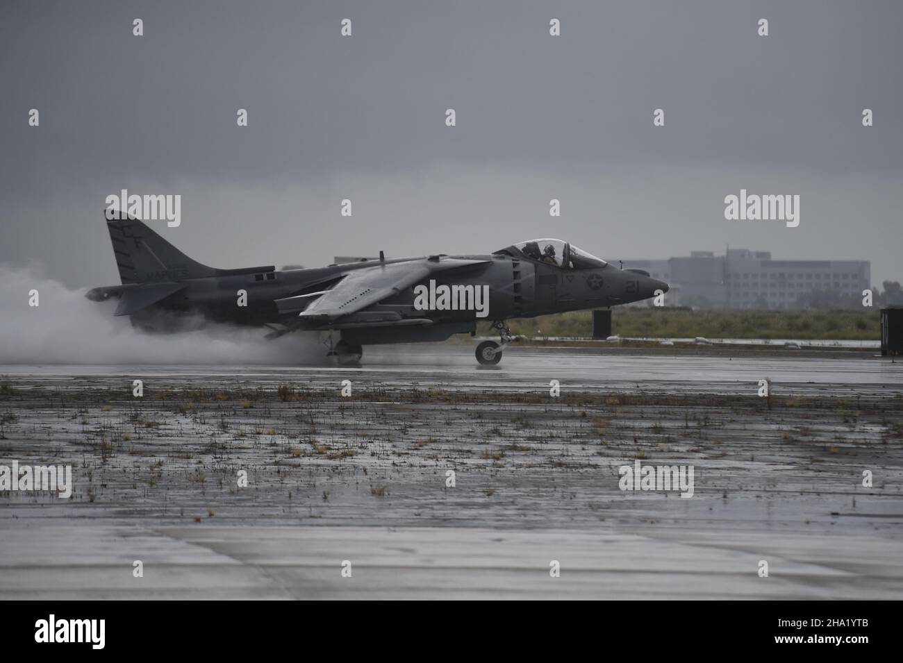 United States Marine Corps AV-8B Harrier II taking off on a wet runway ...