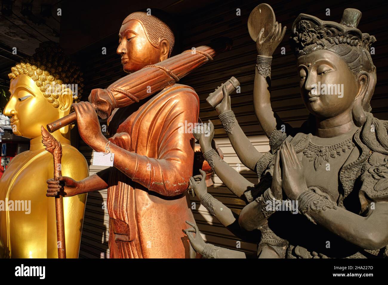 Statues of Buddha, a Buddhist monk & a Taoist goddess placed outside a ...
