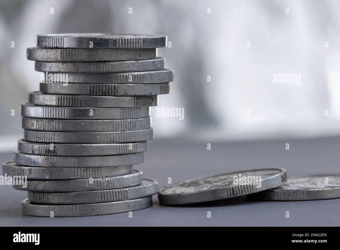 A pile of used silver coins, background blur, financial concept Stock ...