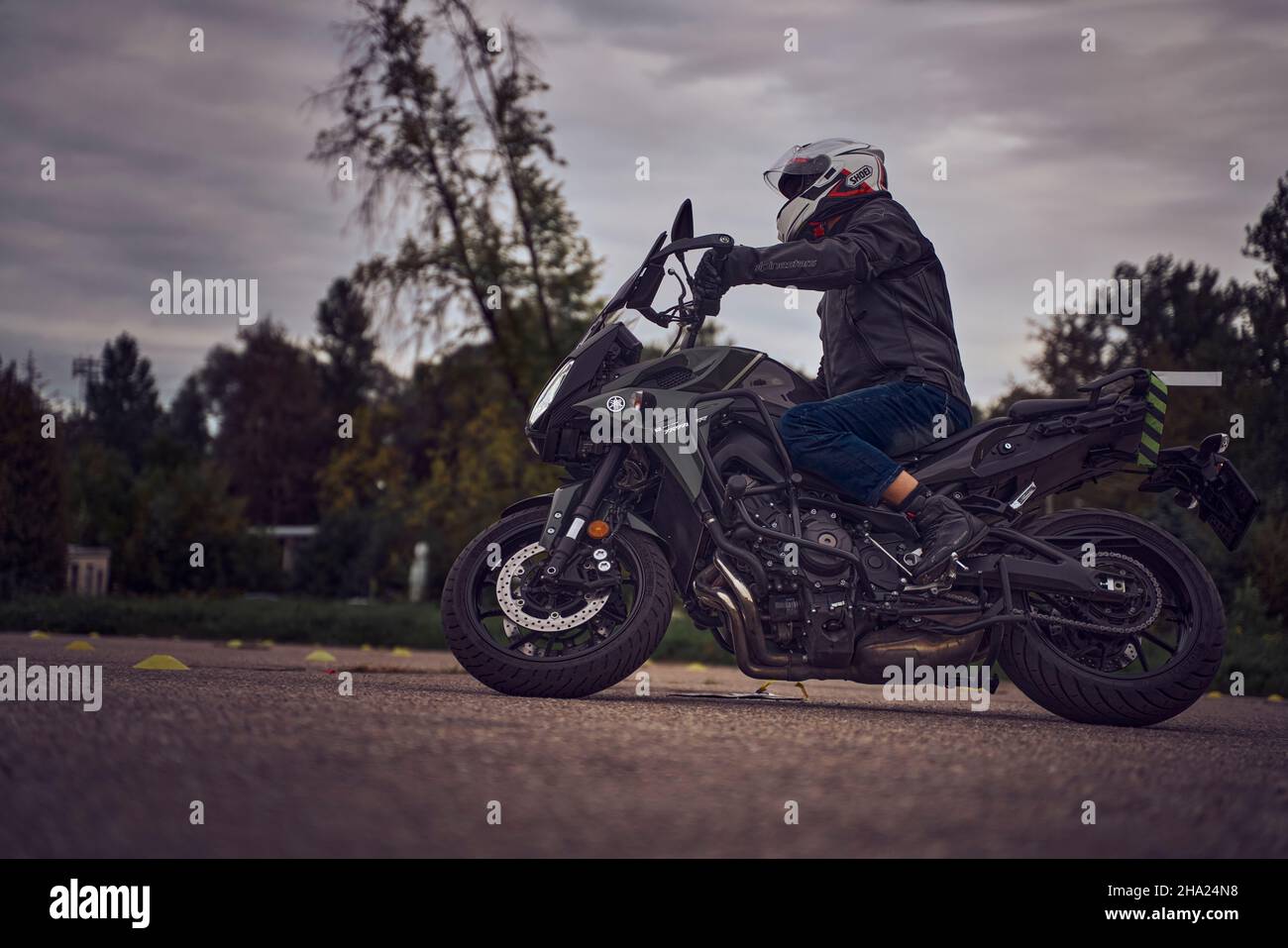 19-09-2021 Riga, Latvia A young man riding a motorcycle on an open road ...