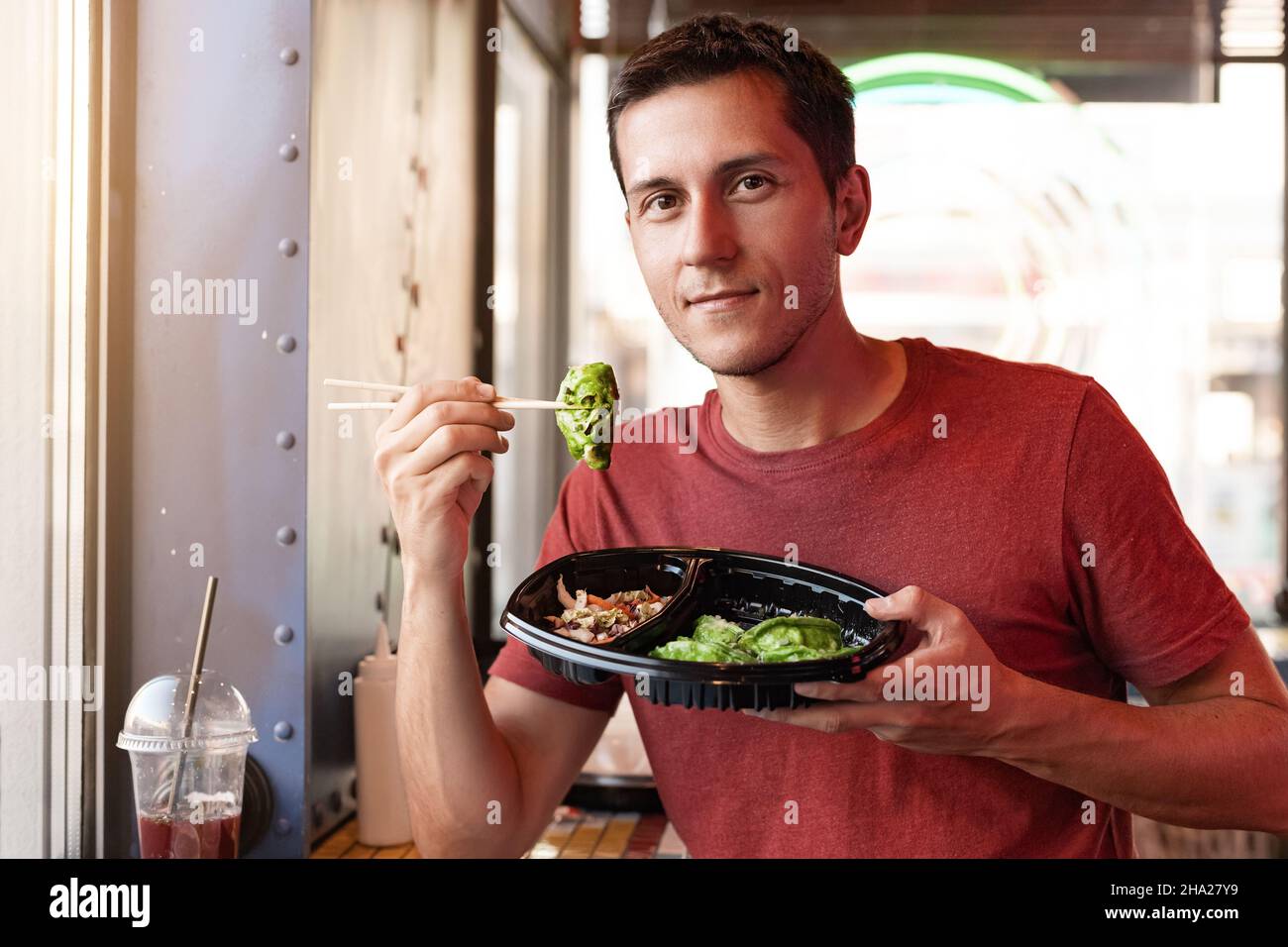 Happy man eating asian japanese dumplings Jiaozi in fastfood restaurant ...