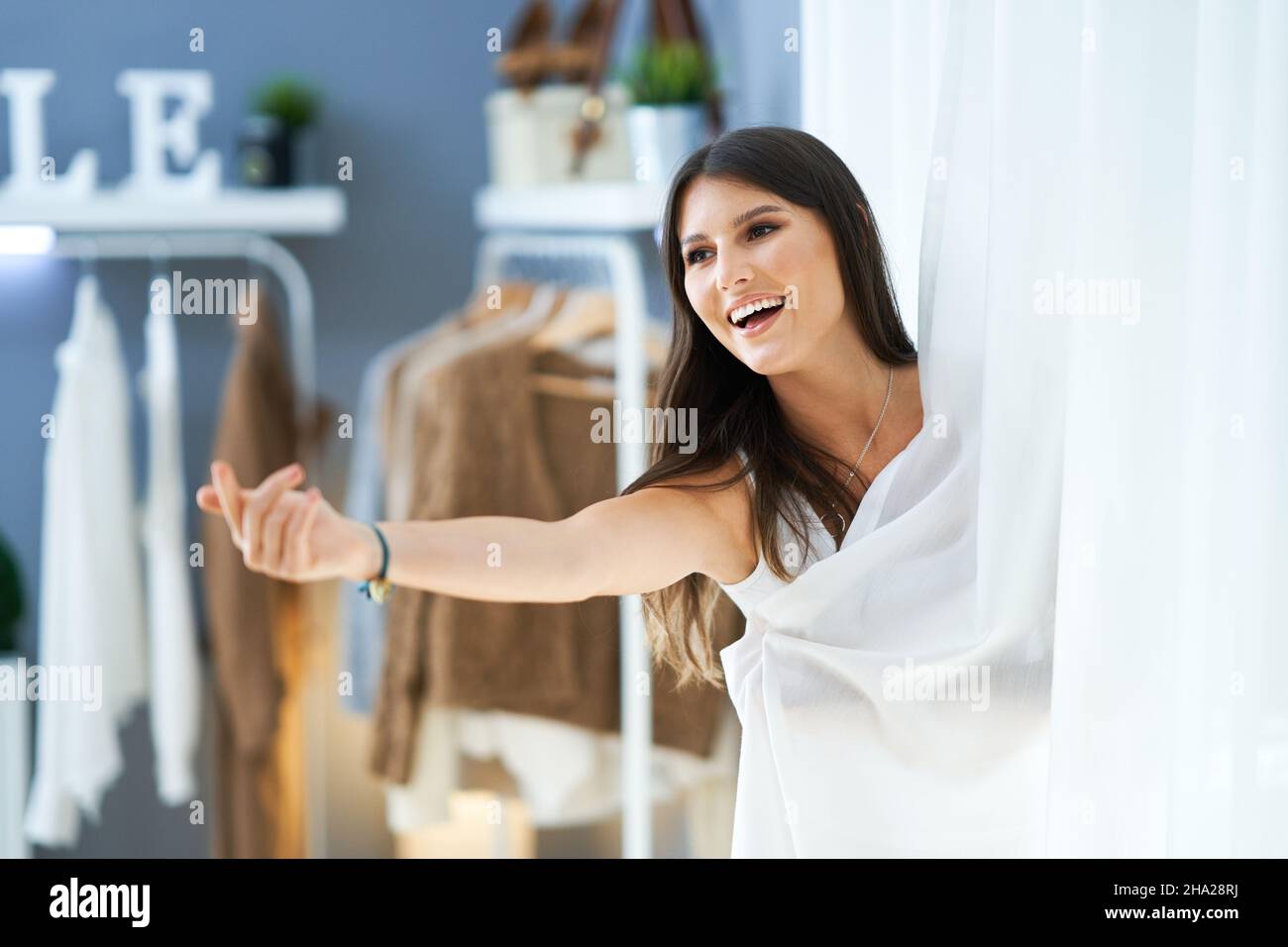 Woman in clothes store in changing room Stock Photo - Alamy