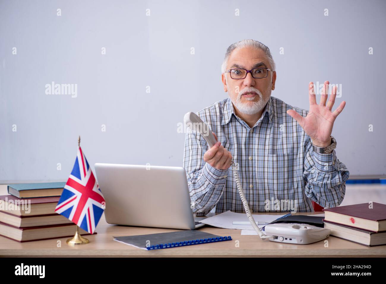 Aged english language teacher in the classroom Stock Photo - Alamy