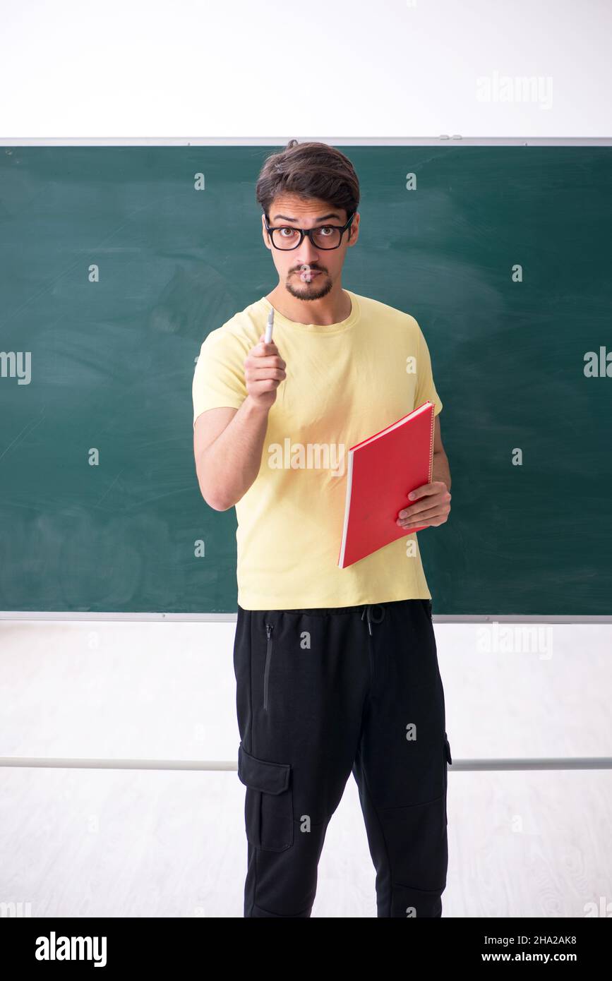 Young student in front of blackboard Stock Photo - Alamy