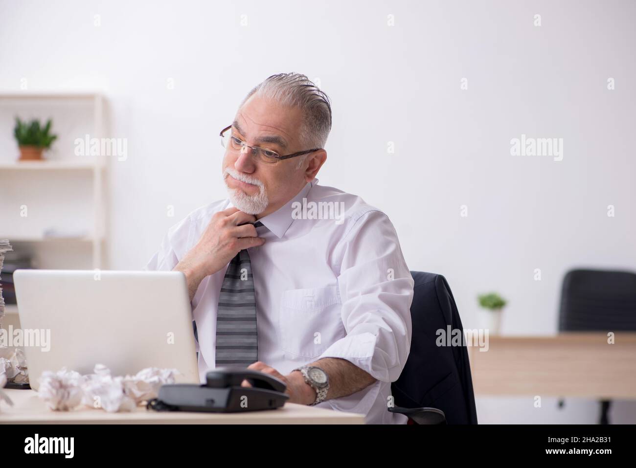 Old businessman employee in brainstorming concept Stock Photo - Alamy