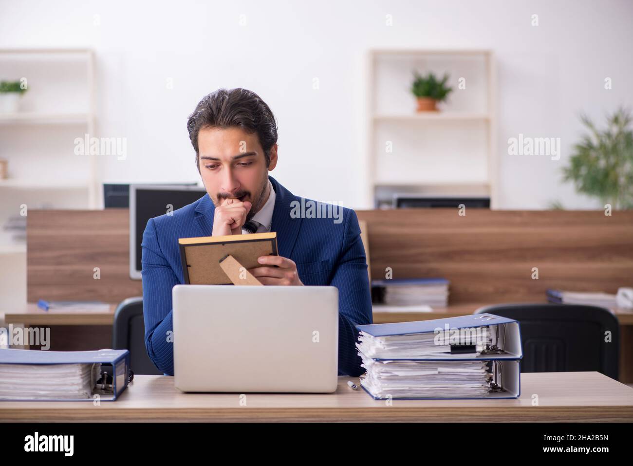 Young employee missing girlfriend at workplace Stock Photo - Alamy