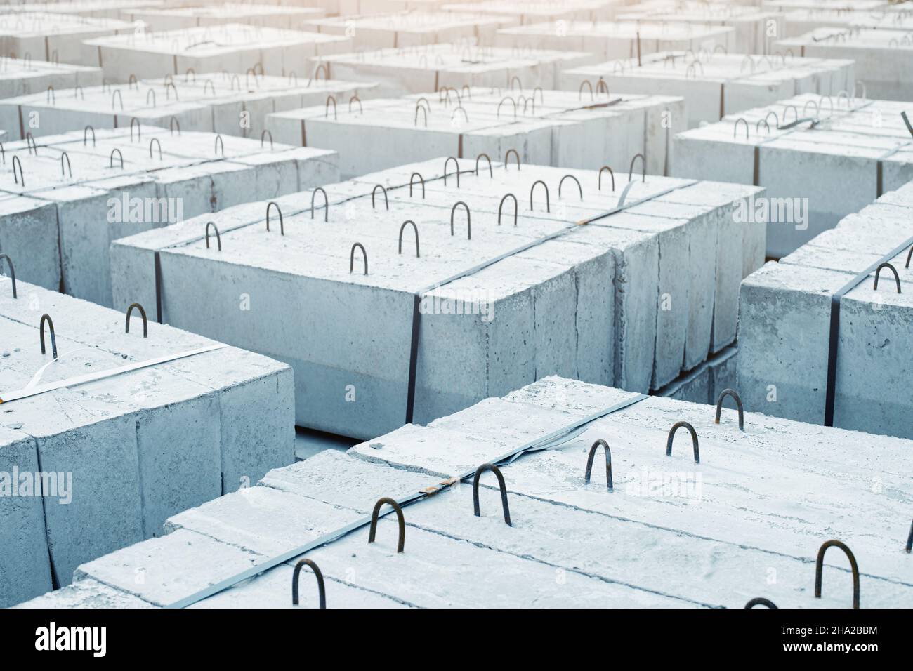 A lot of building cement blocks in an extensive open-air warehouse ...