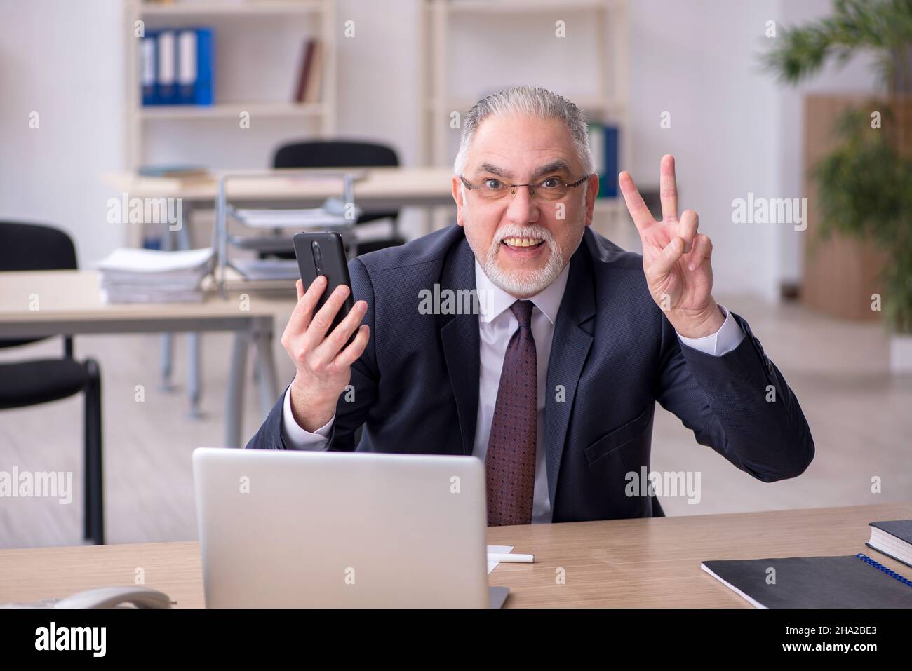 Old businessman employee working in the office Stock Photo - Alamy