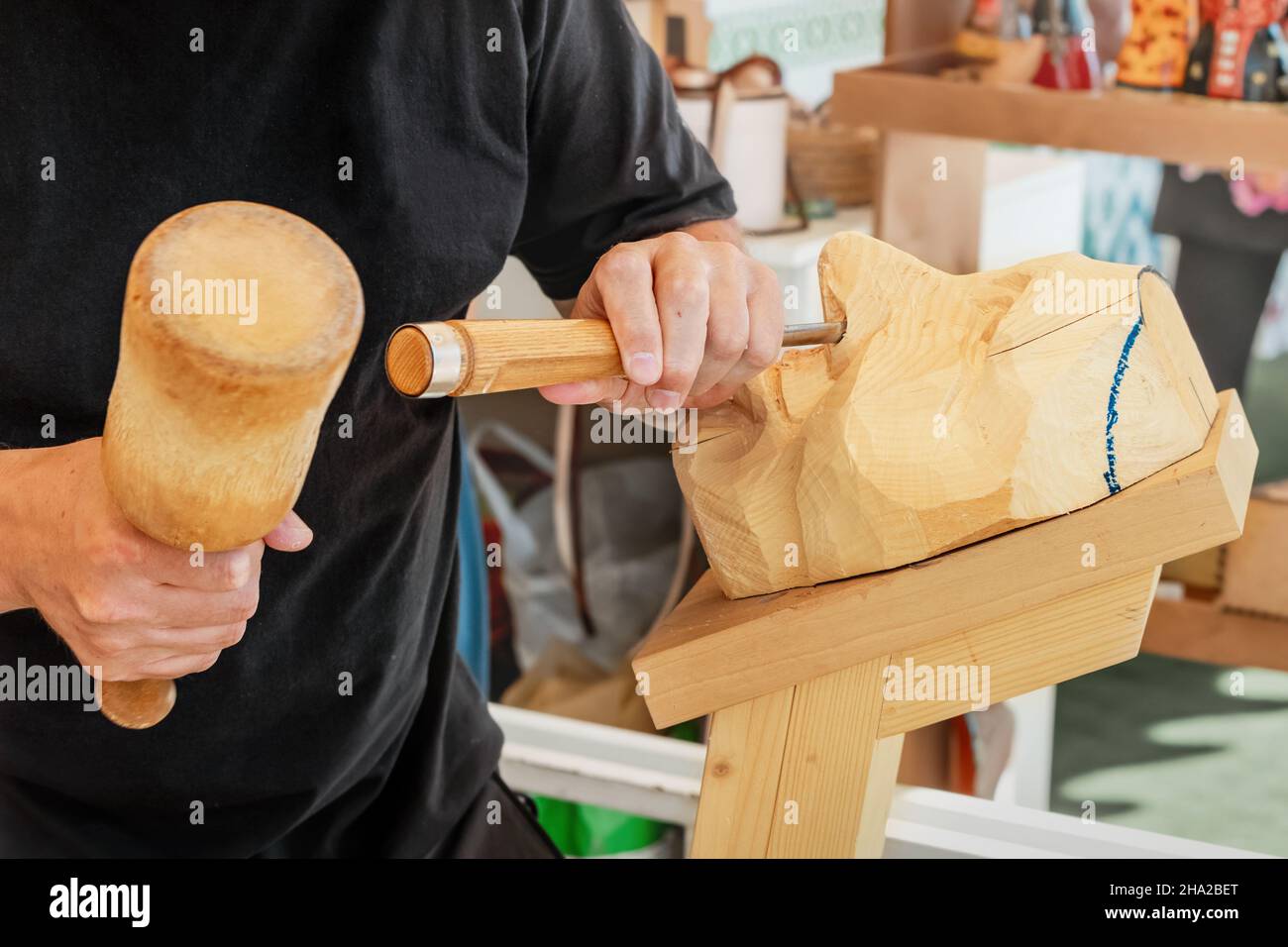 06 July 2021, Ufa, Russia: Craftsman artist and carpenter cutting ...