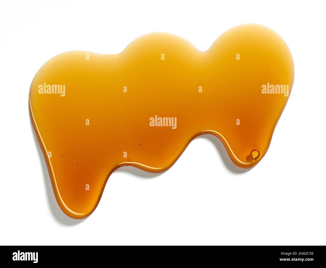 flowing brown sugar syrup isolated on white background Stock Photo - Alamy