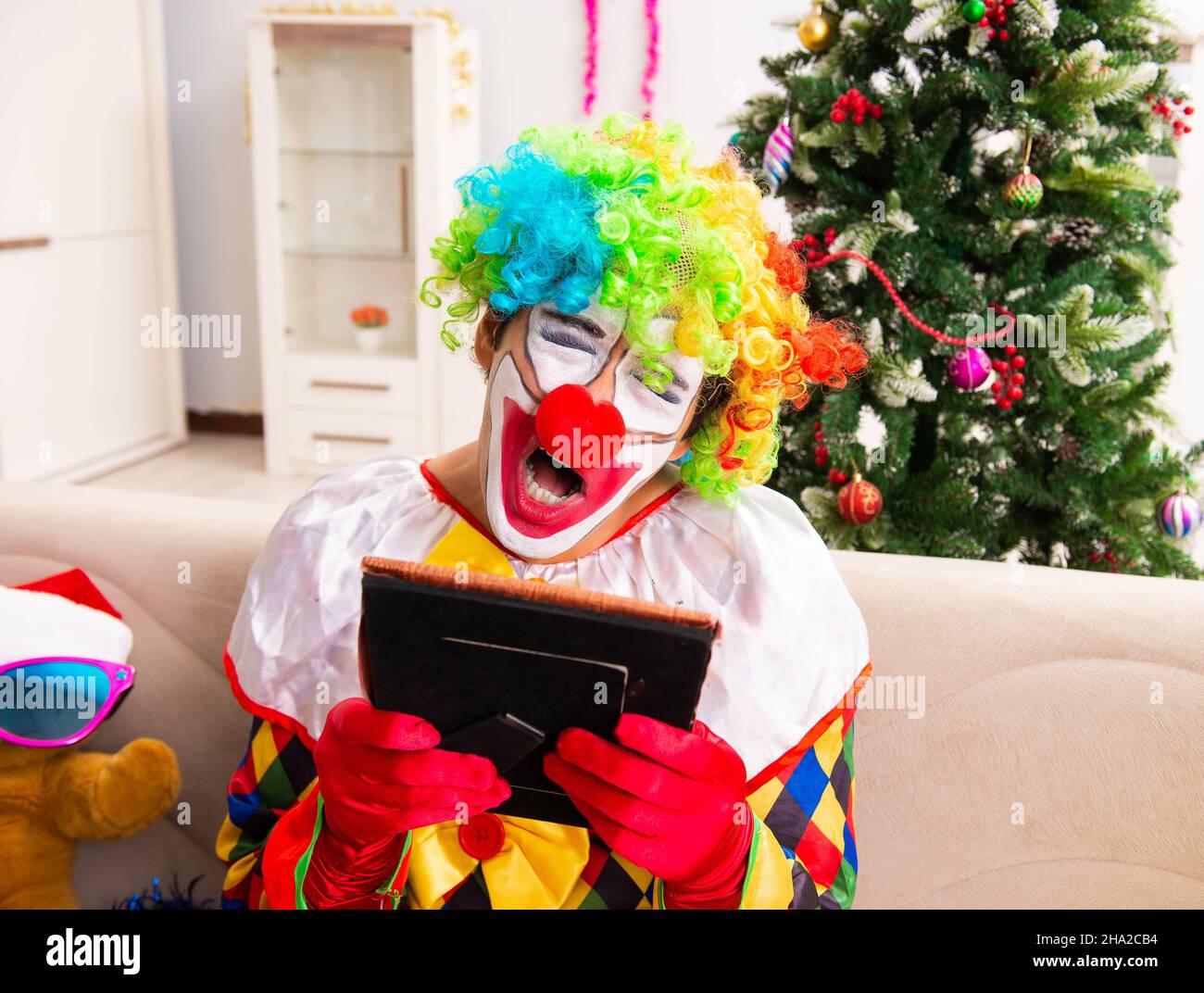 The funny clown in christmas celebration concept Stock Photo - Alamy