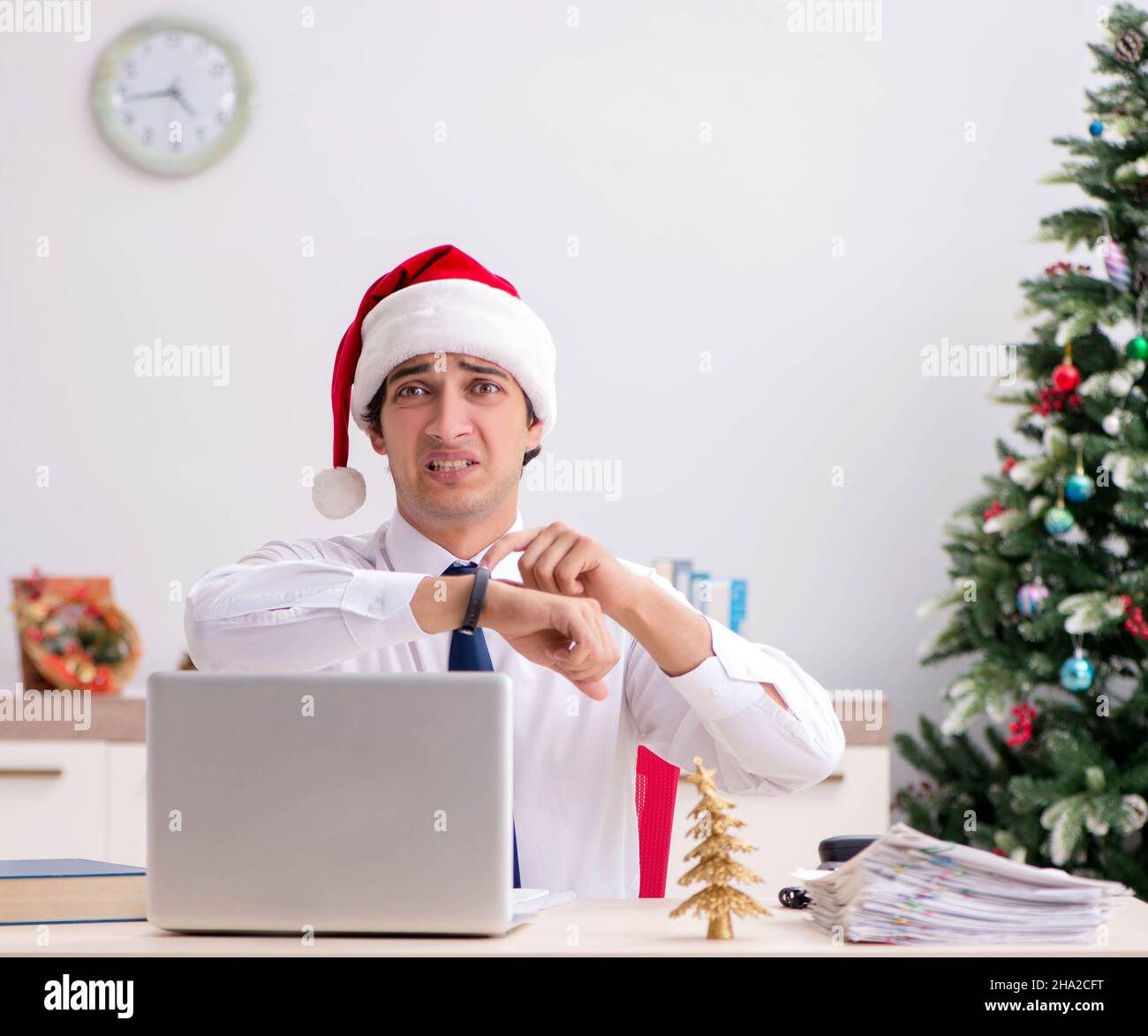 The young worker working in office on christmas shift Stock Photo - Alamy