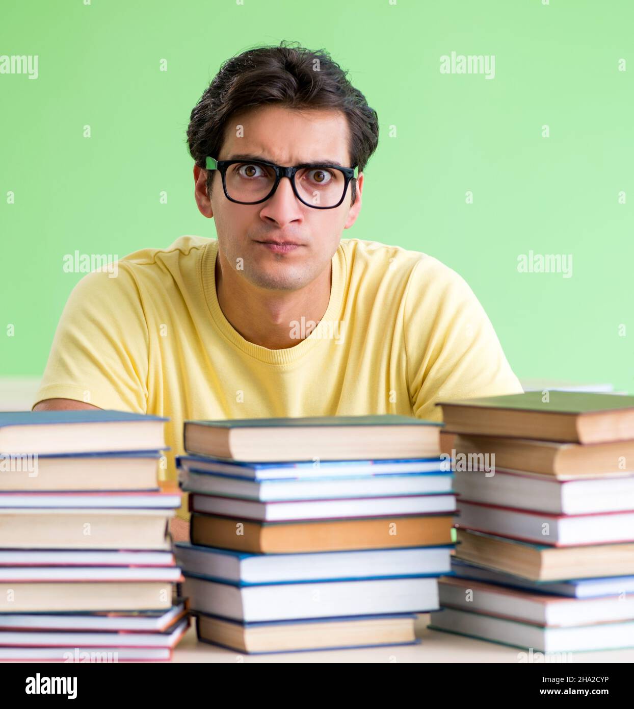 The student with too many books to read before exam Stock Photo - Alamy
