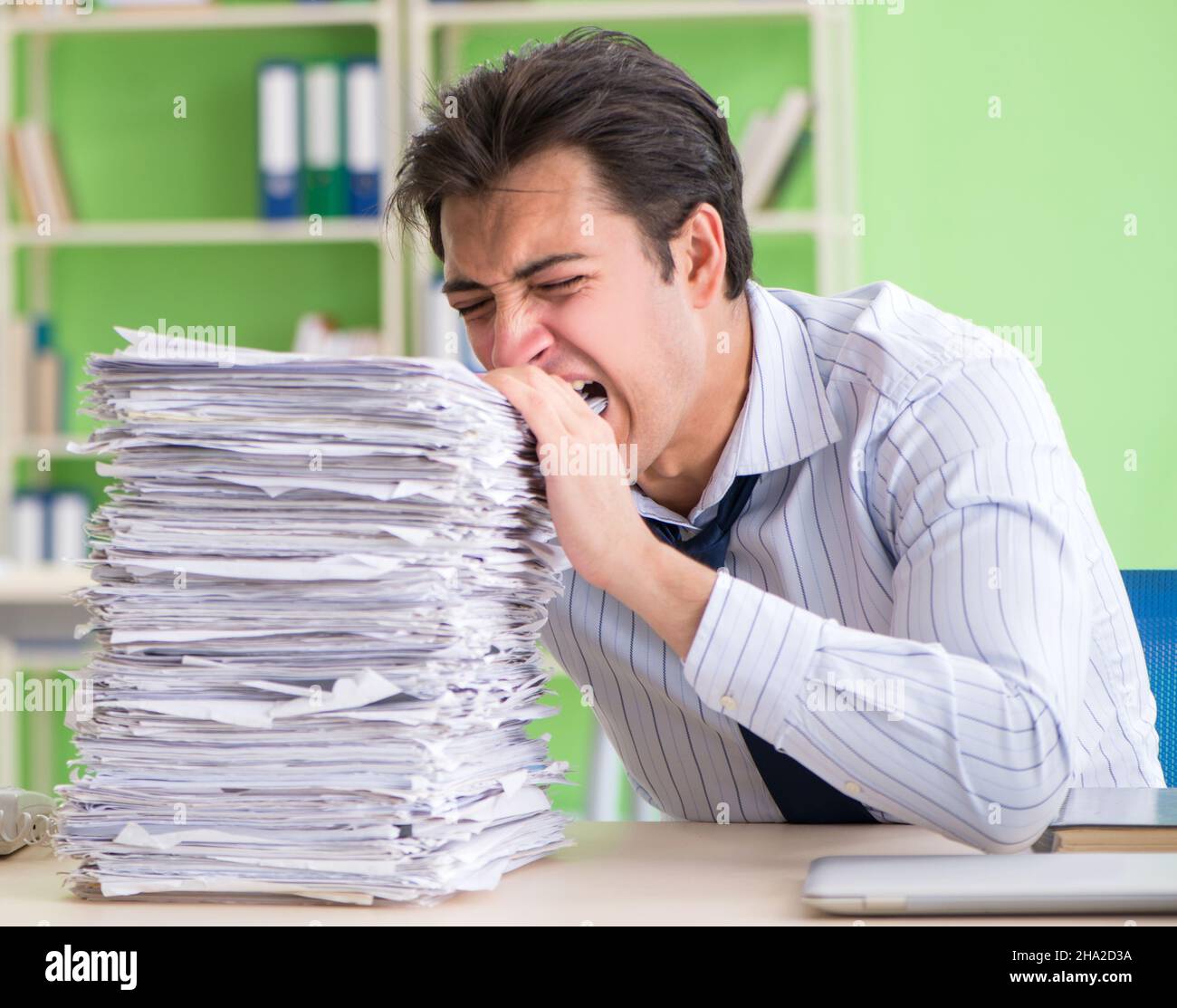 The businessman having problems with paperwork and workload Stock Photo ...