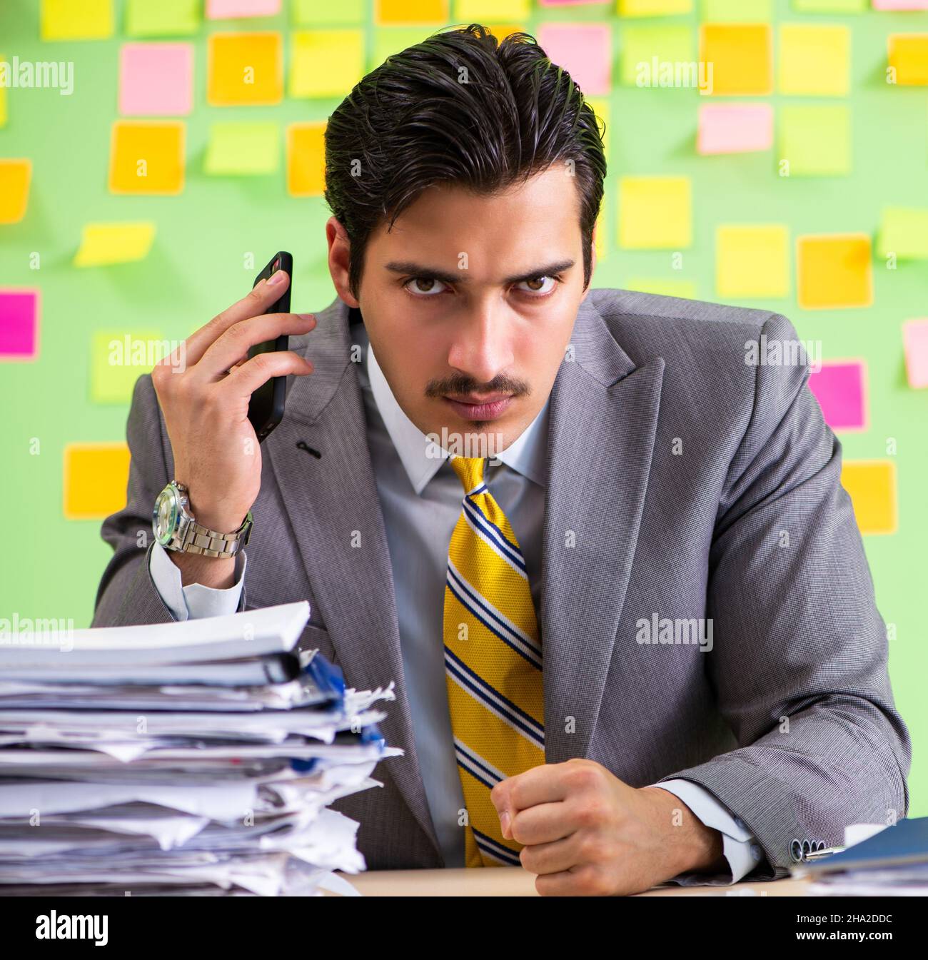 The businessman having trouble with his priorities Stock Photo - Alamy