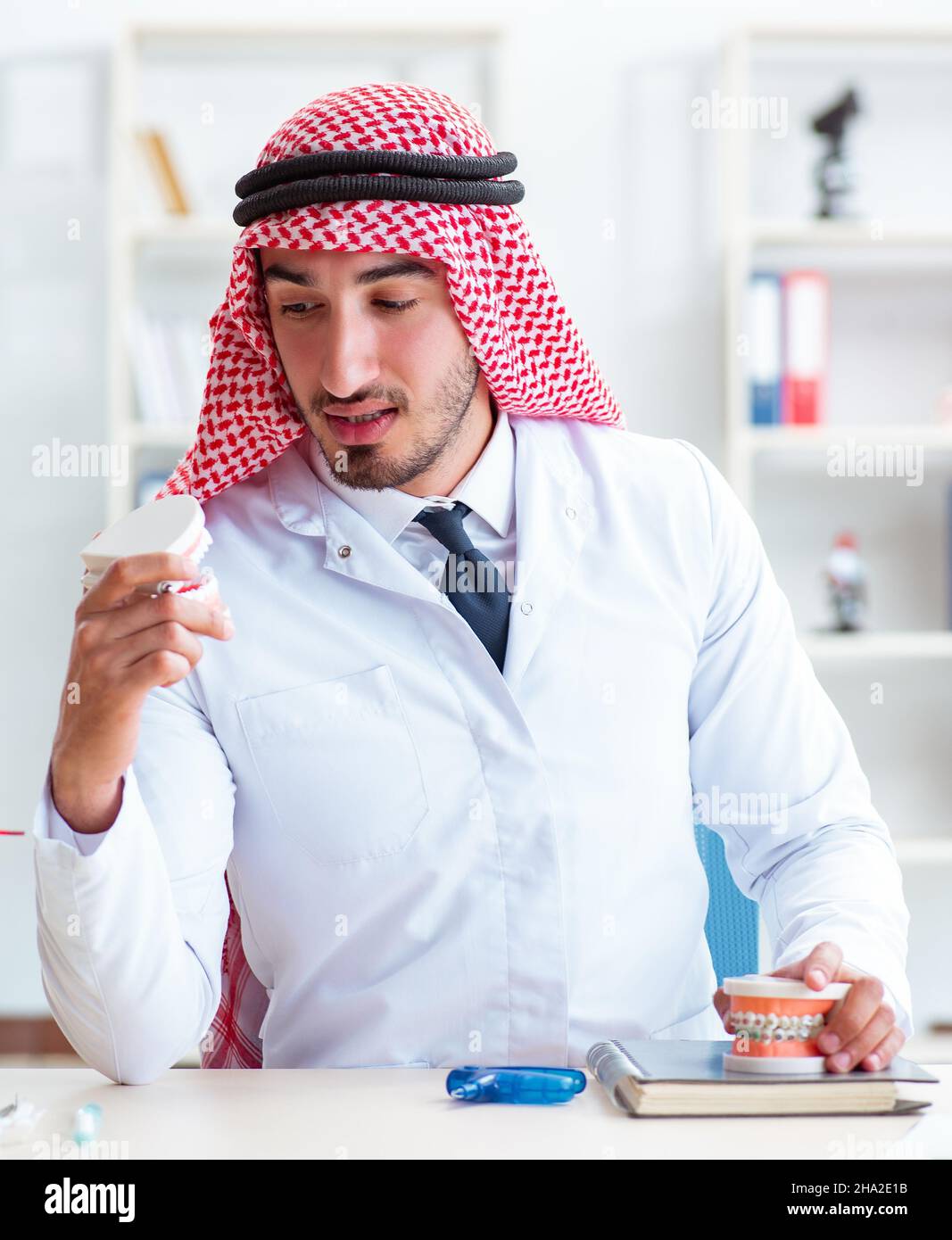 The arab dentist working on new teeth implant Stock Photo - Alamy