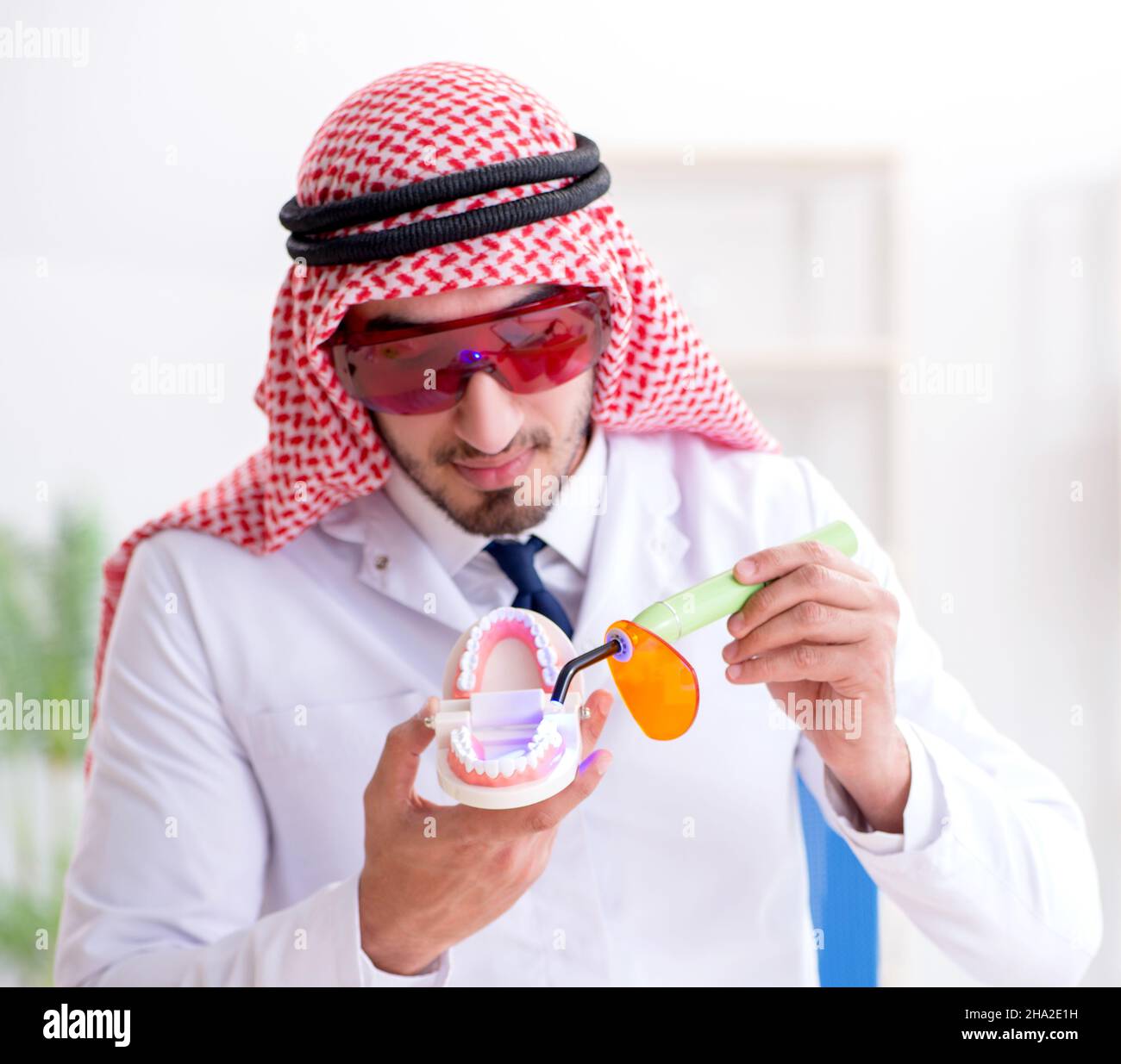 The arab dentist working on new teeth implant Stock Photo - Alamy