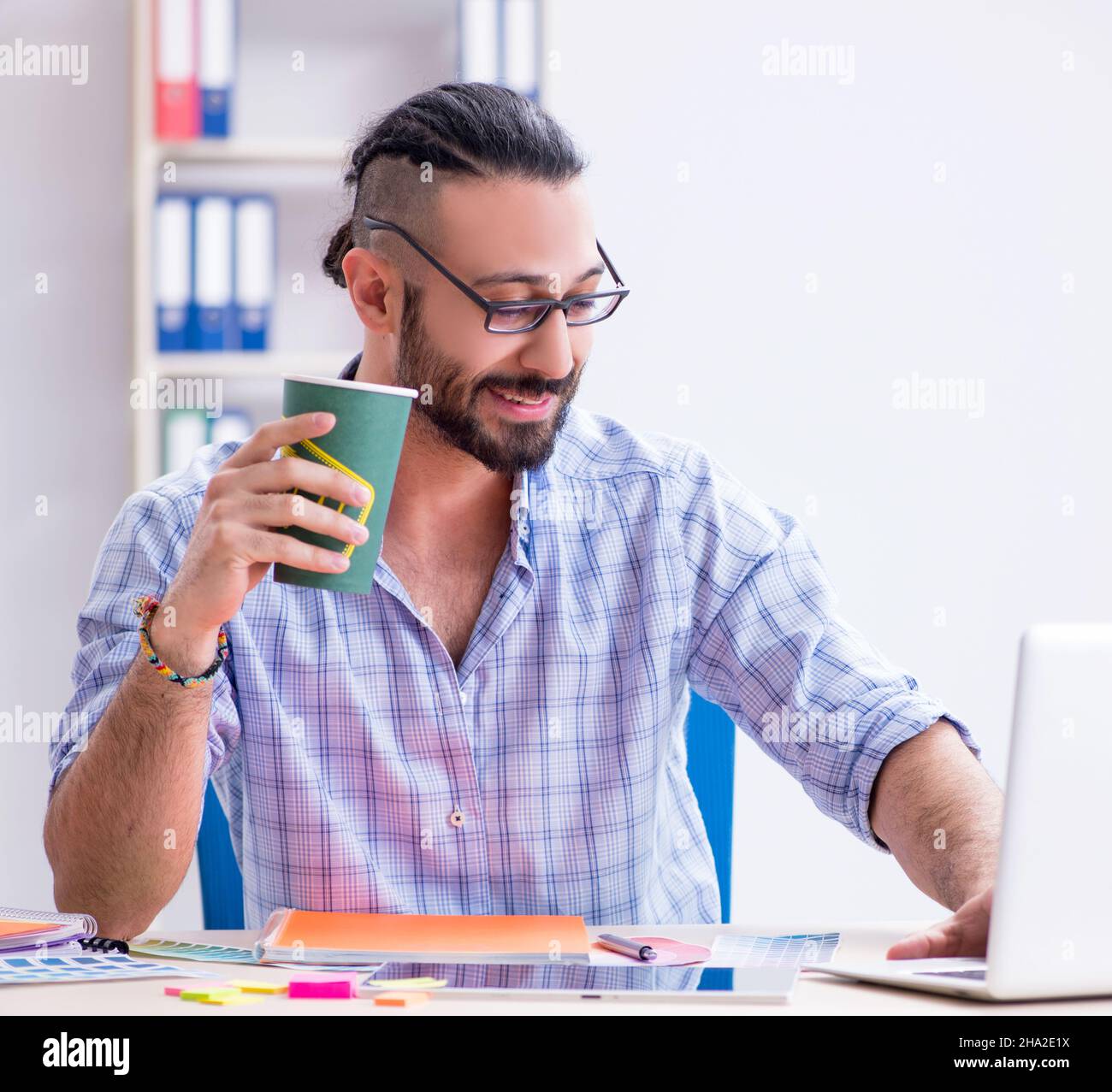 The young designer working in his studio on new project Stock Photo - Alamy