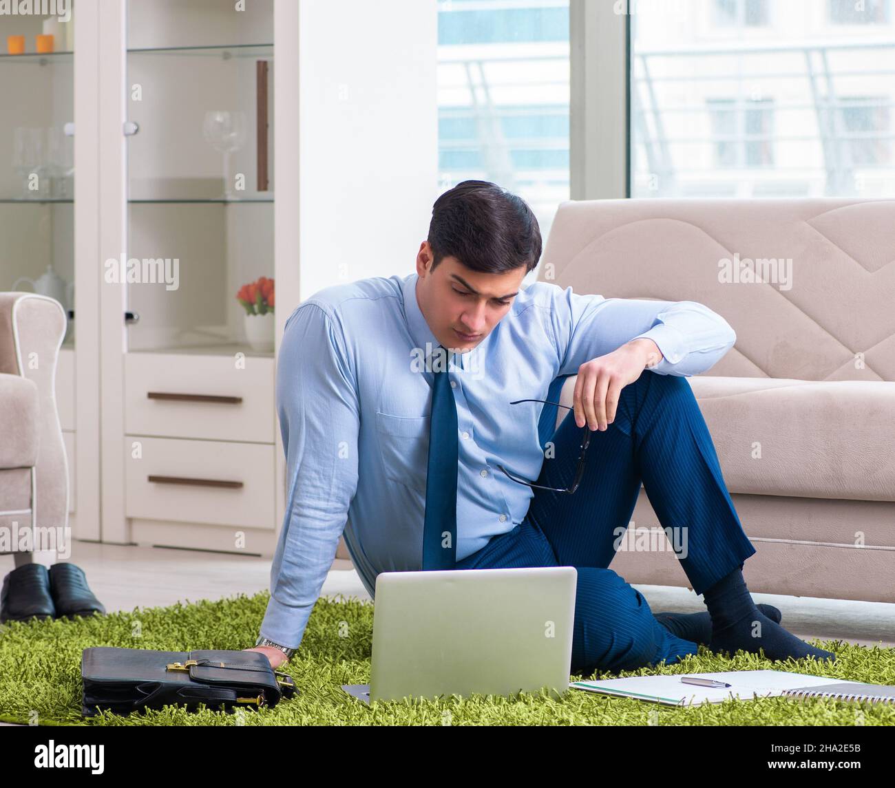 The businessman taking work home and working overtime Stock Photo - Alamy