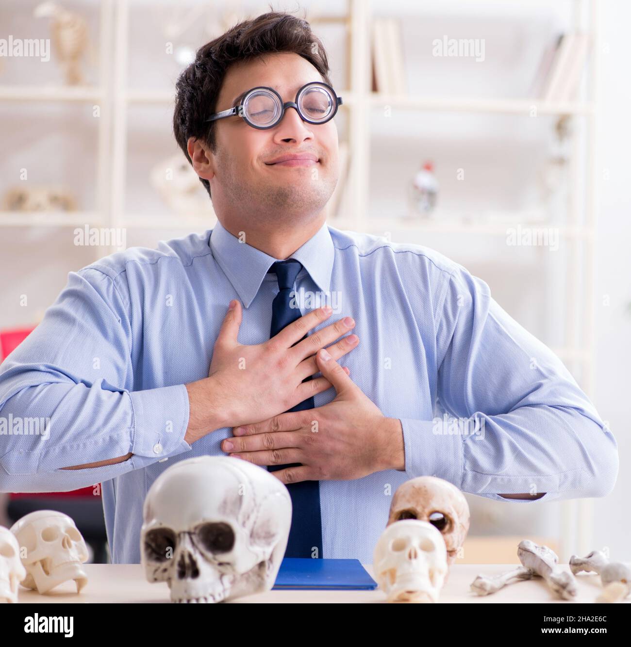 The funny crazy professor studying human skeleton Stock Photo - Alamy