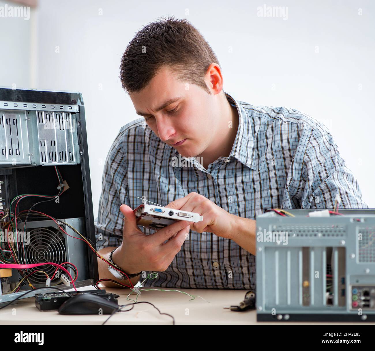 The young technician repairing computer in workshop Stock Photo - Alamy